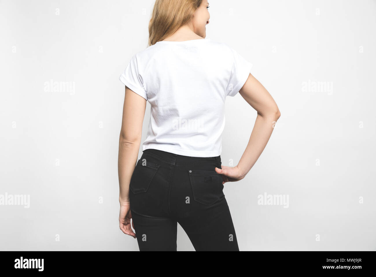 back view of young woman in blank t-shirt on white Stock Photo - Alamy