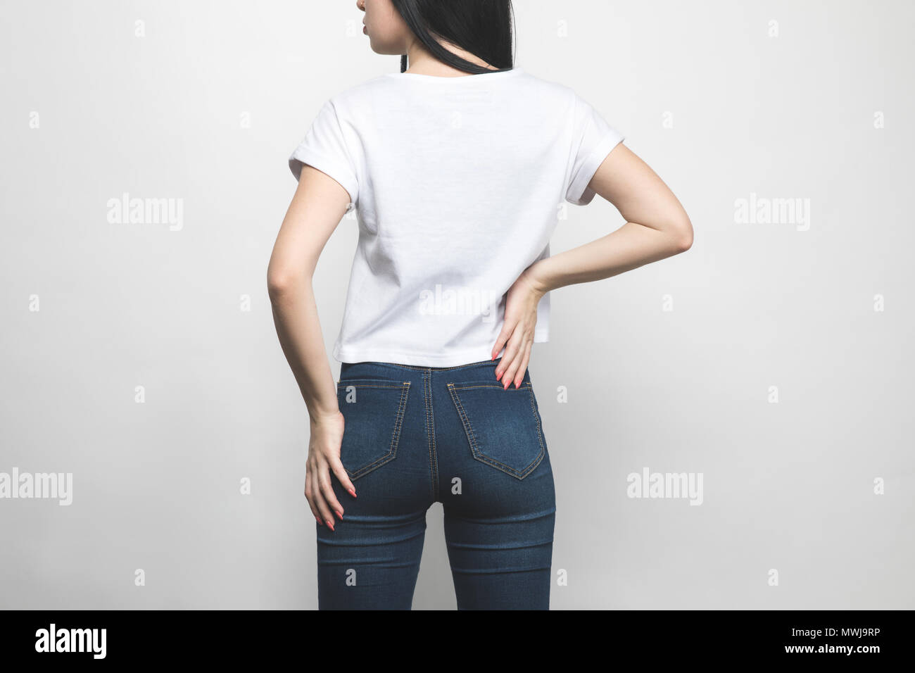 back view of attractive young woman in blank t-shirt on white Stock ...