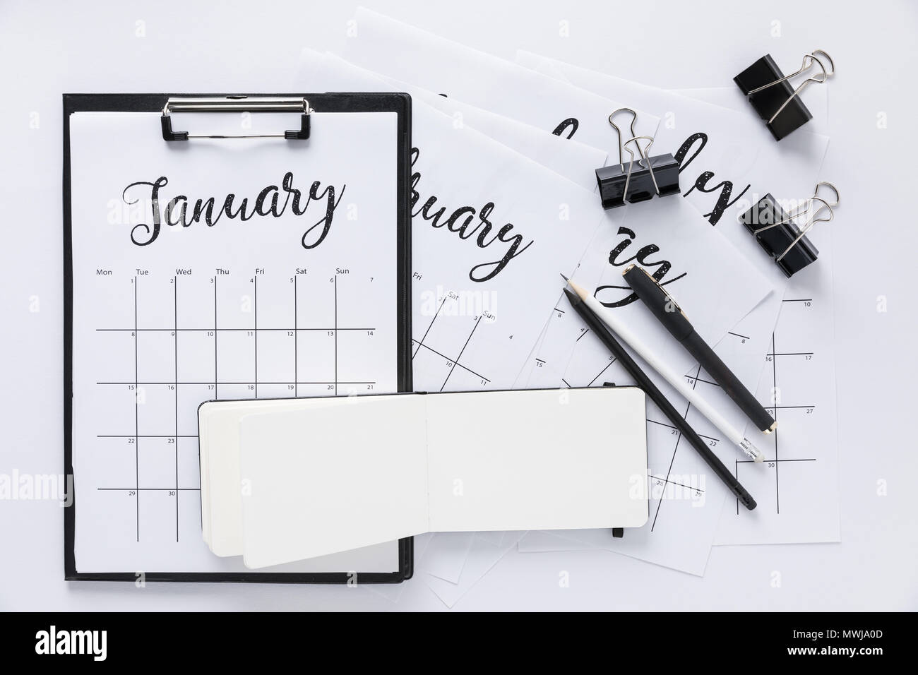 top view of arrangement of office supplies and calendar isolated on ...