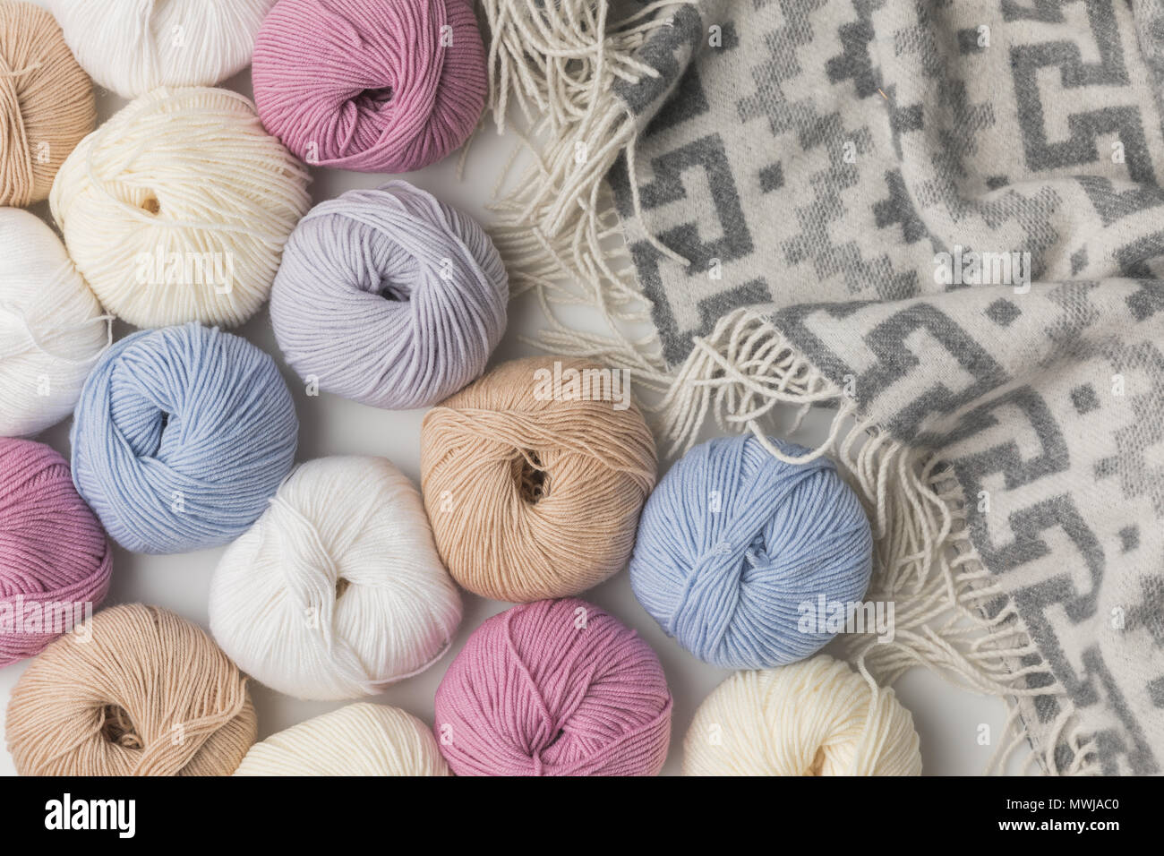 scattered colored yarn balls and blanket on white background Stock ...