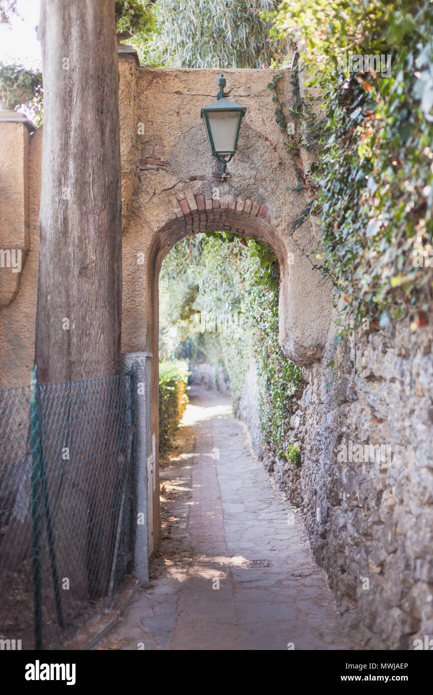 beautiful ancient arch with lantern on cozy street in Portovenere ...