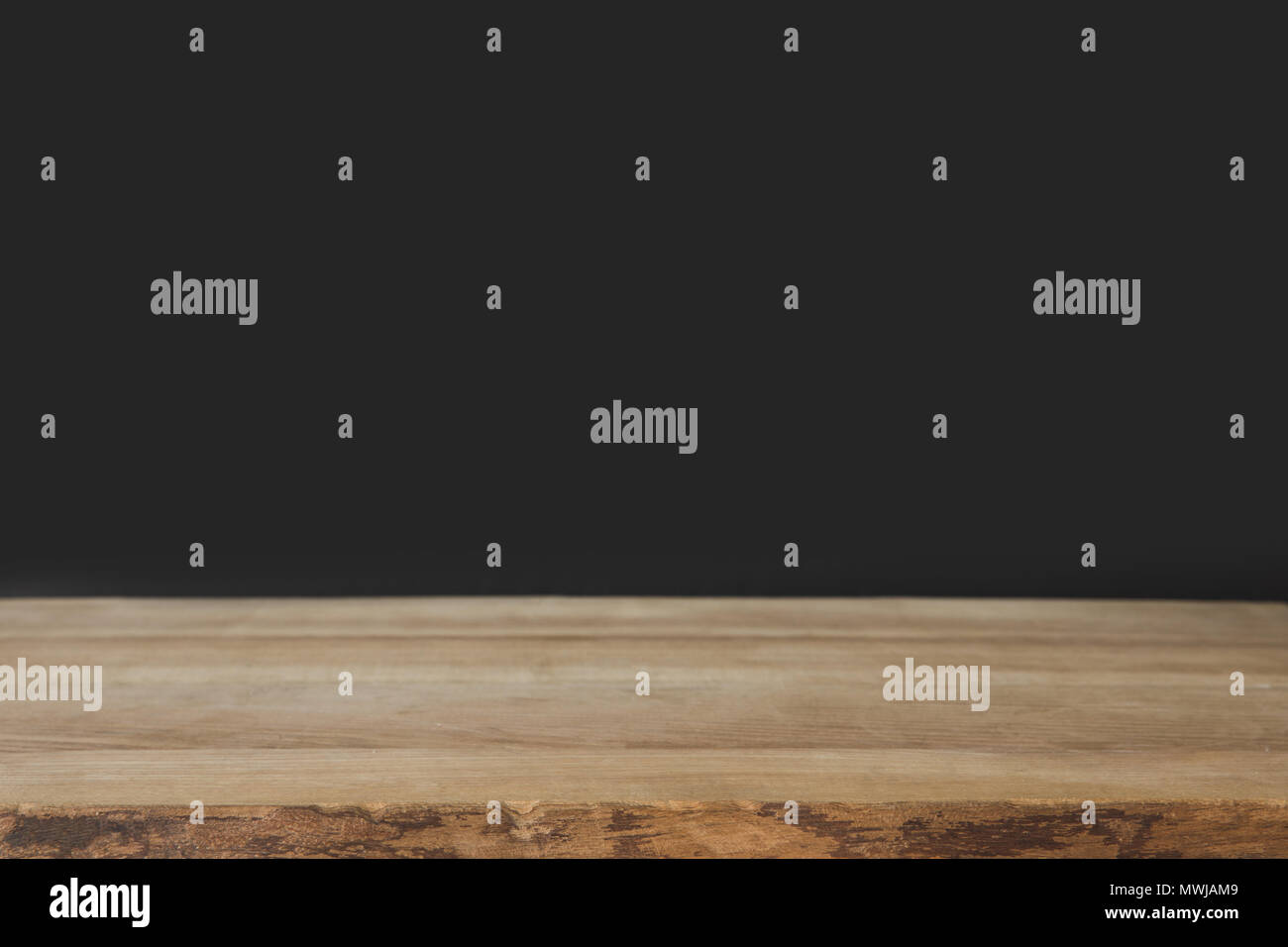 black wall and wooden brown table Stock Photo - Alamy