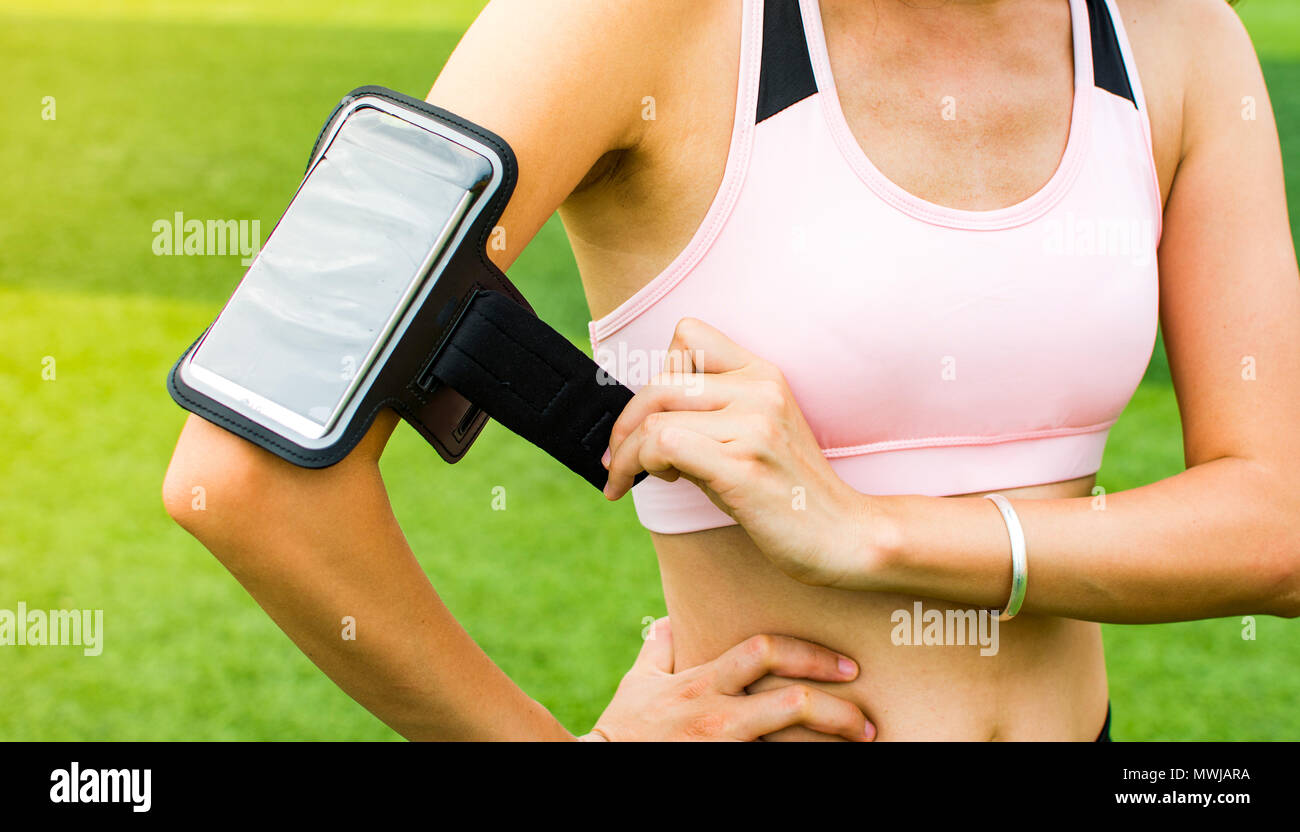 Girl setting up smartphone to track jogging sport activity Stock Photo ...