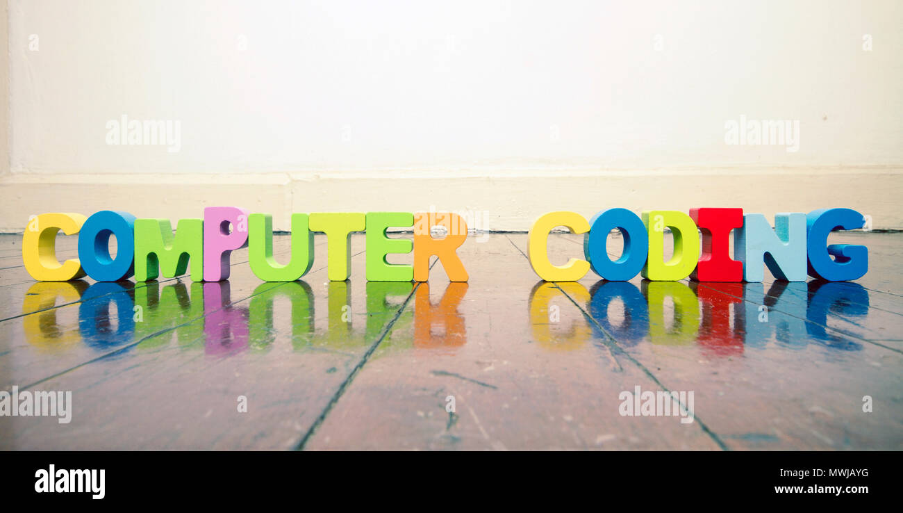 the words COMPUTER CODING with wooden letters on an old wooden floor ...