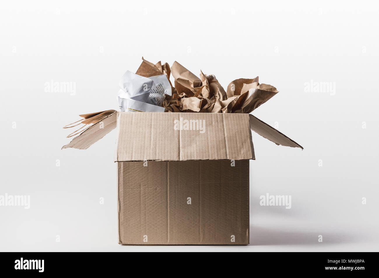 close up view of cardboard box with papers inside isolated on white ...