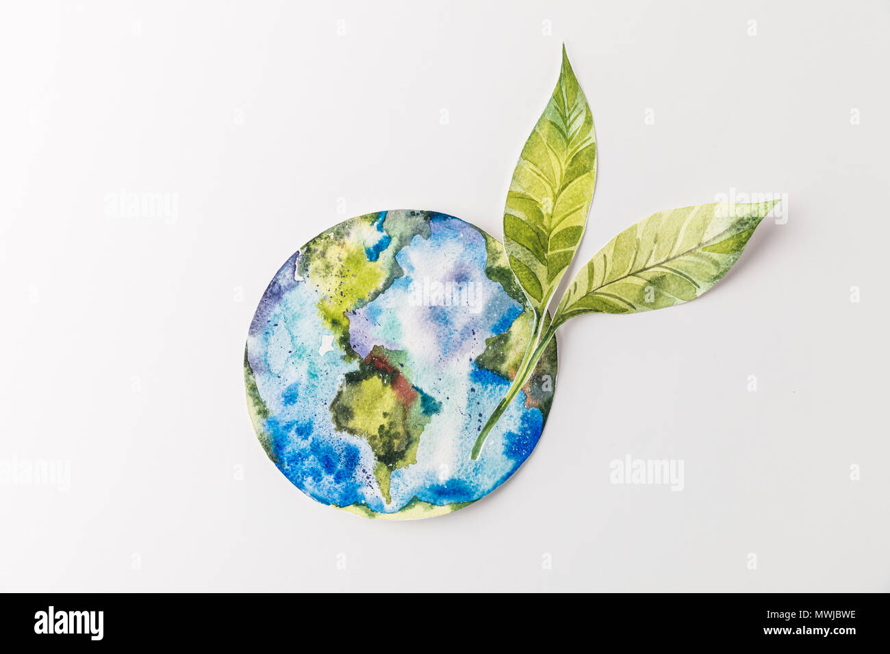 top view of handmade colorful paper globe with green leaves isolated on ...