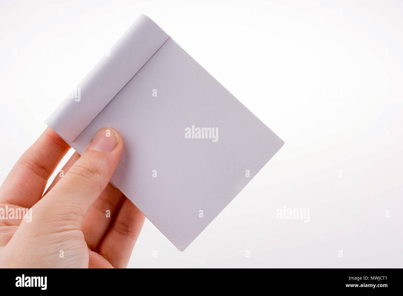 White little notebook in hand on a white background Stock Photo - Alamy