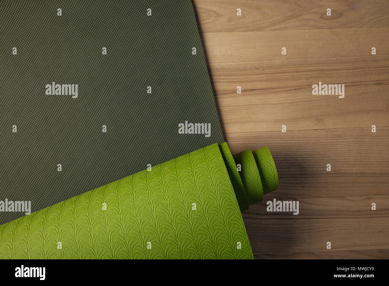 top view of green yoga mat on brown floor Stock Photo - Alamy