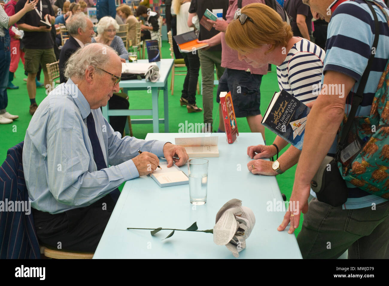 Alexander McCall Smith signing books for fans in the bookshop at Hay ...