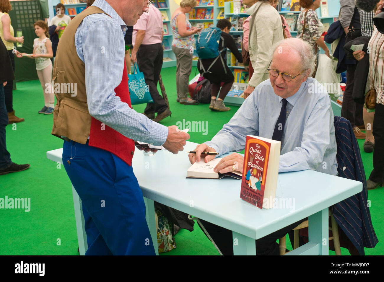Alexander McCall Smith signing books for fans in the bookshop at Hay ...