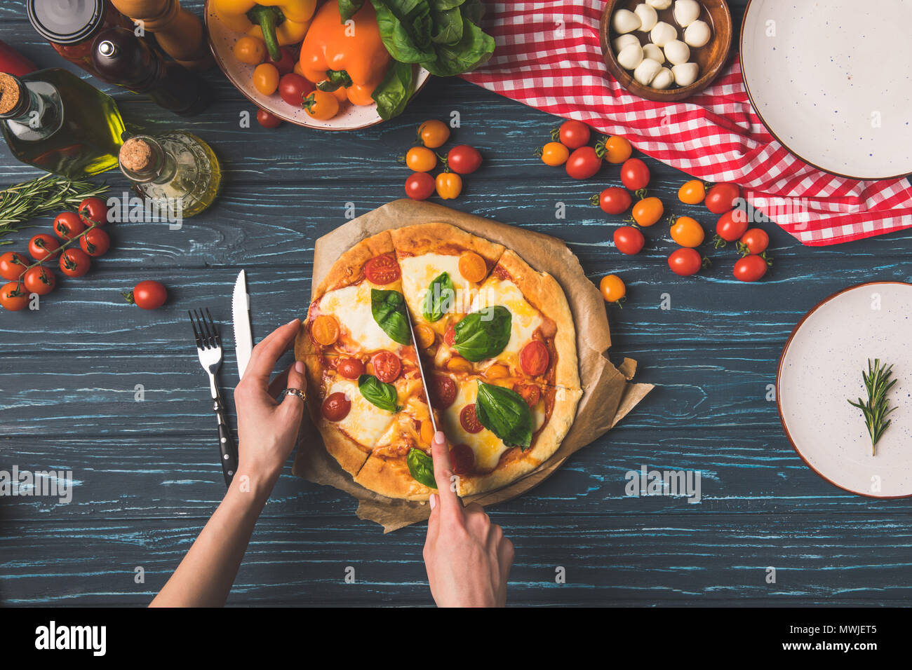 cropped image of woman cutting homemade pizza Stock Photo - Alamy