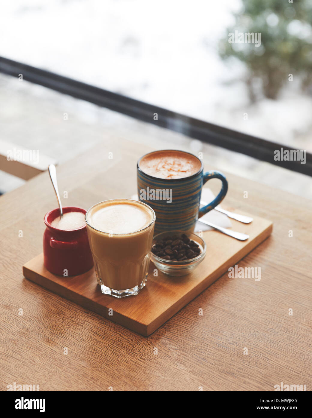 Hot coffee with milk in table in coffee shop Stock Photo - Alamy