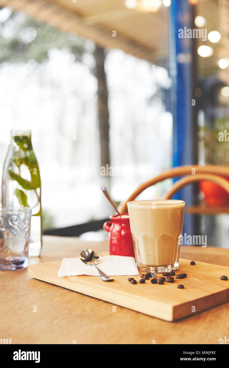 Restaurant table with coffee served in glass Stock Photo - Alamy