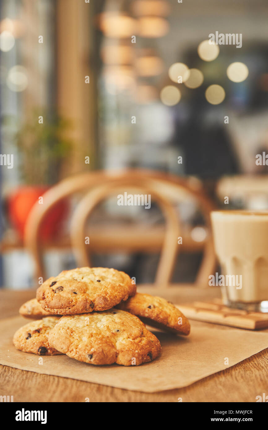 Chocolate chip cookies in cafe on table with coffee Stock Photo - Alamy
