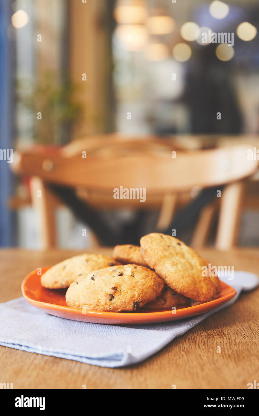 Chocolate chip cookies on plate in cafe Stock Photo - Alamy