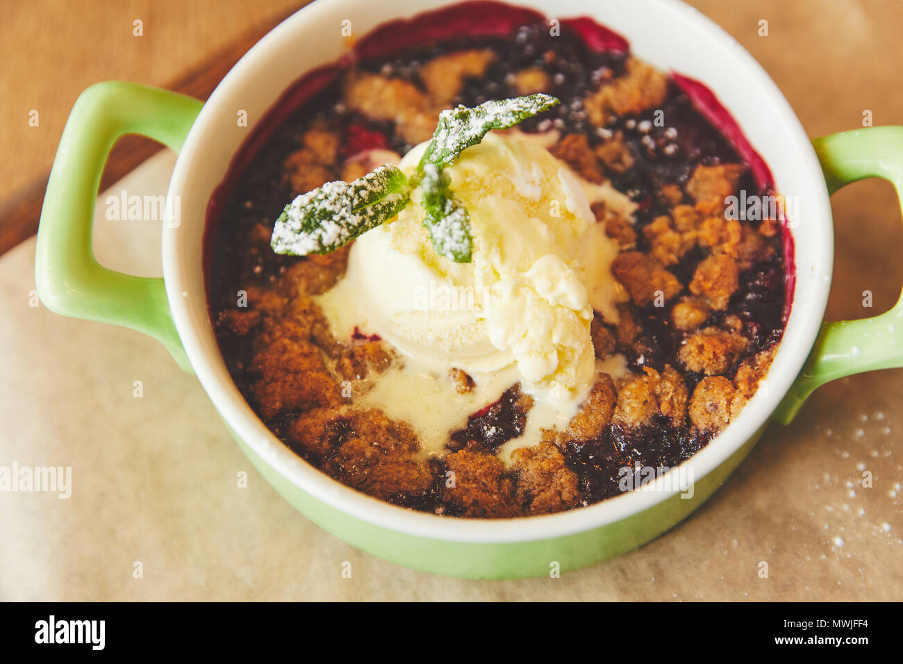 Crumble served in pot with ice cream Stock Photo - Alamy