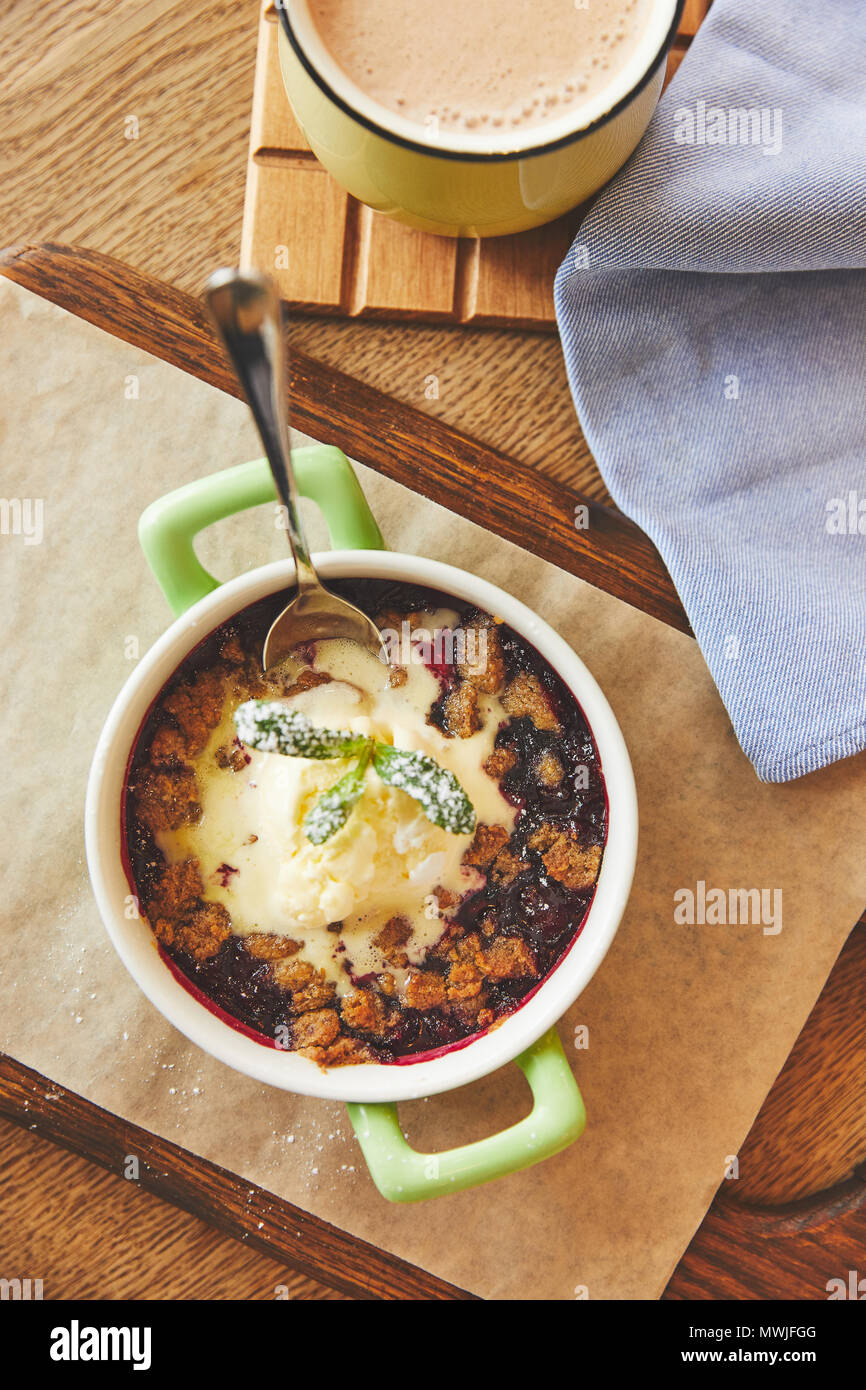 Crumble served in pot with ice cream and coffee Stock Photo - Alamy