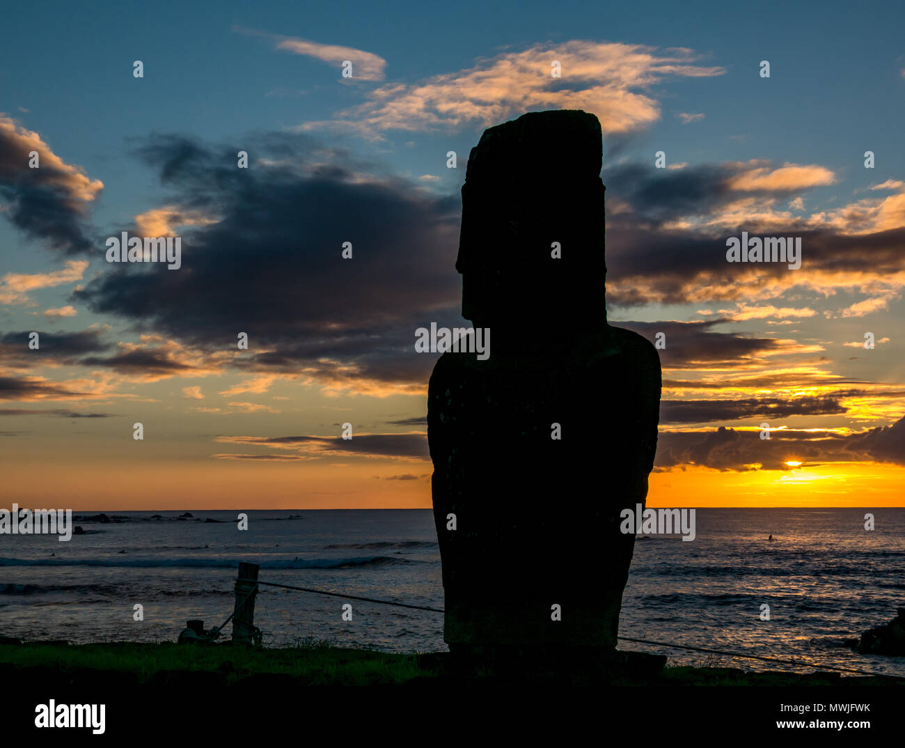 Dramatic colourful orange sunset at Tahai Moai, with stone Moai figure ...