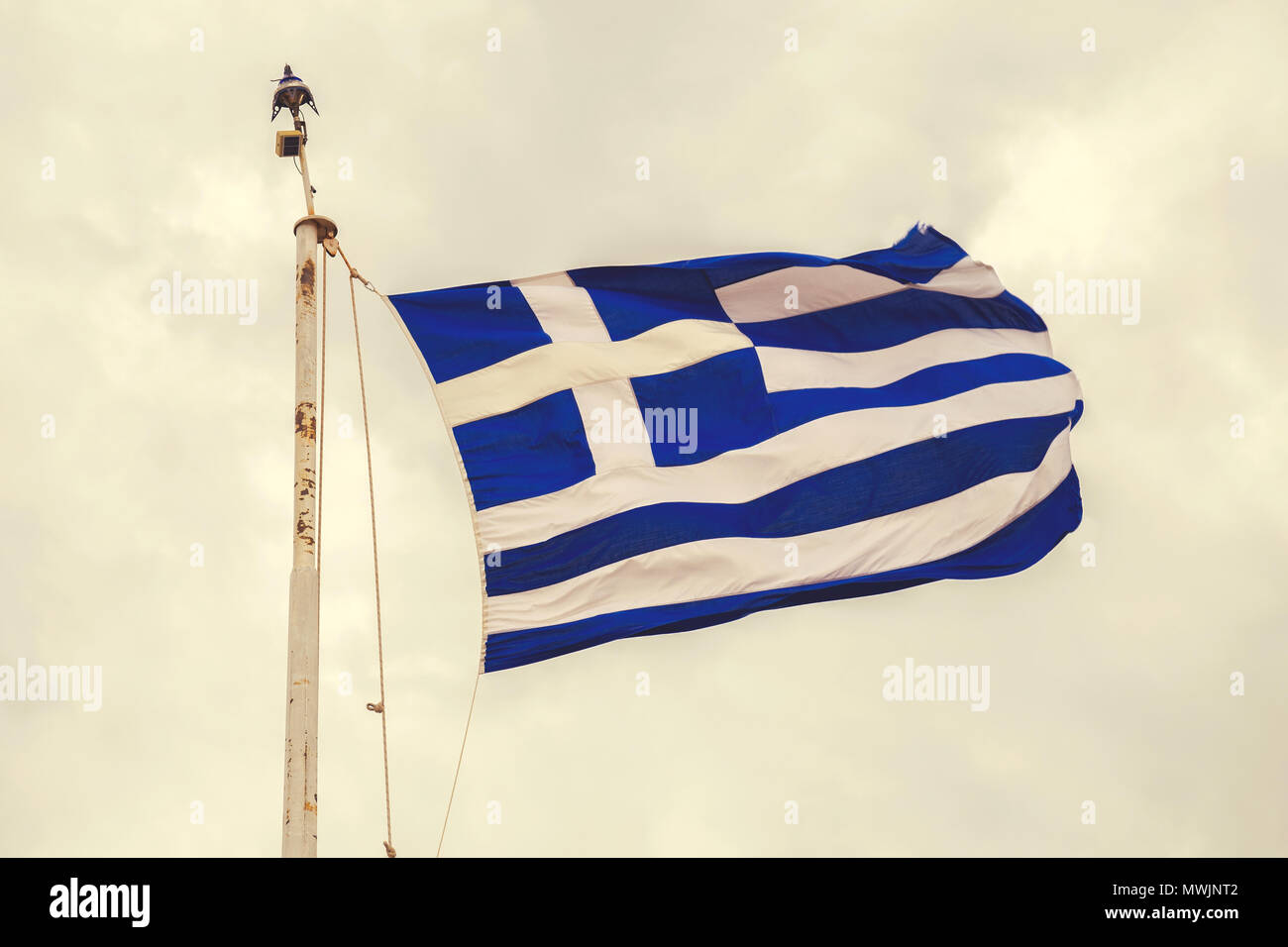 ATHEN, GREECE - JULY 19, 2016: The Greek flag on the top of the ancient ...