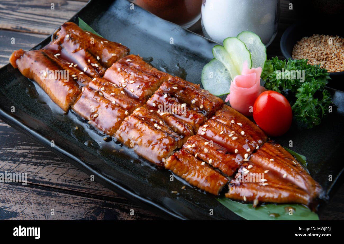 Cut Japanese eel grilled or Unagi ibaraki set on plate in Japanese style with studio lighting ...