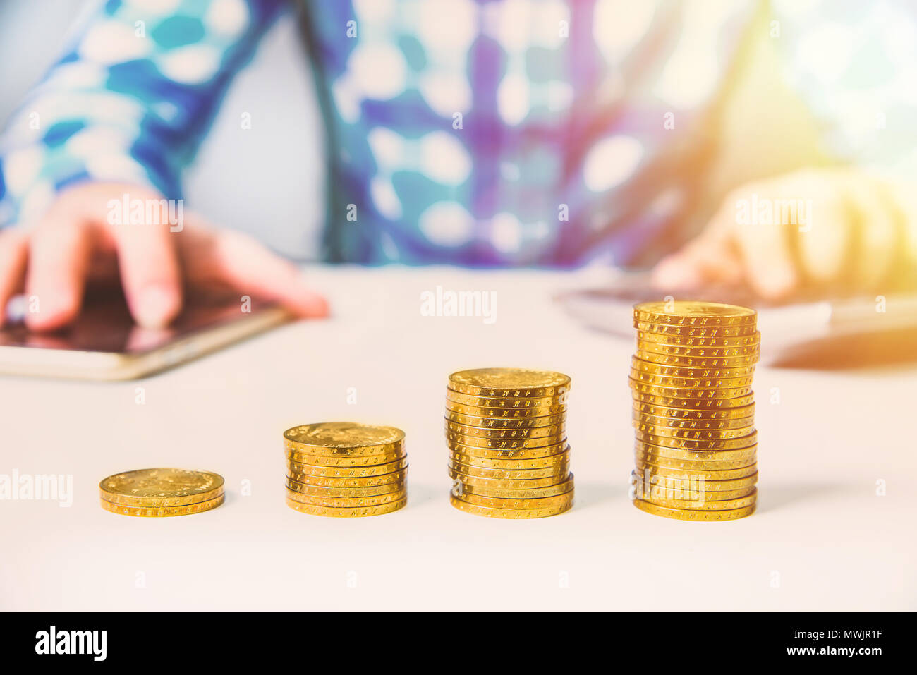 Concept of enrichment and financial growth. Gold coins. Man working ...