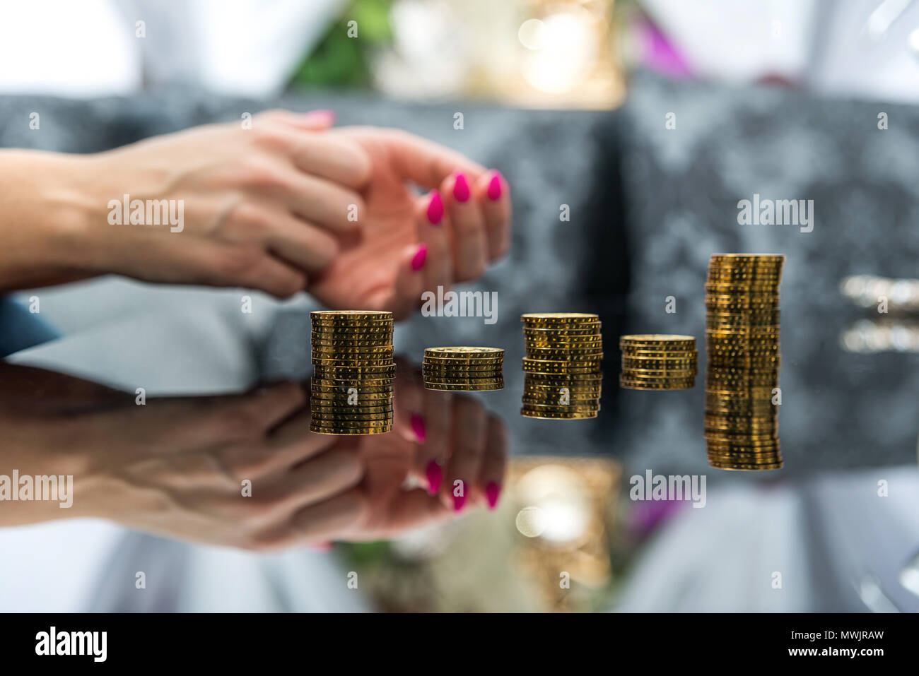 Concept of enrichment and financial growth. Gold coins. Female hands ...