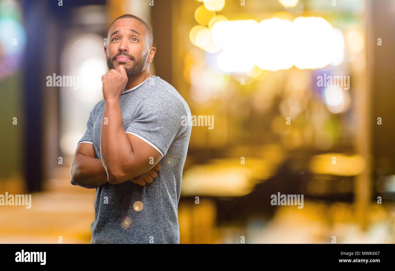 African american man with beard thinking and looking up expressing ...