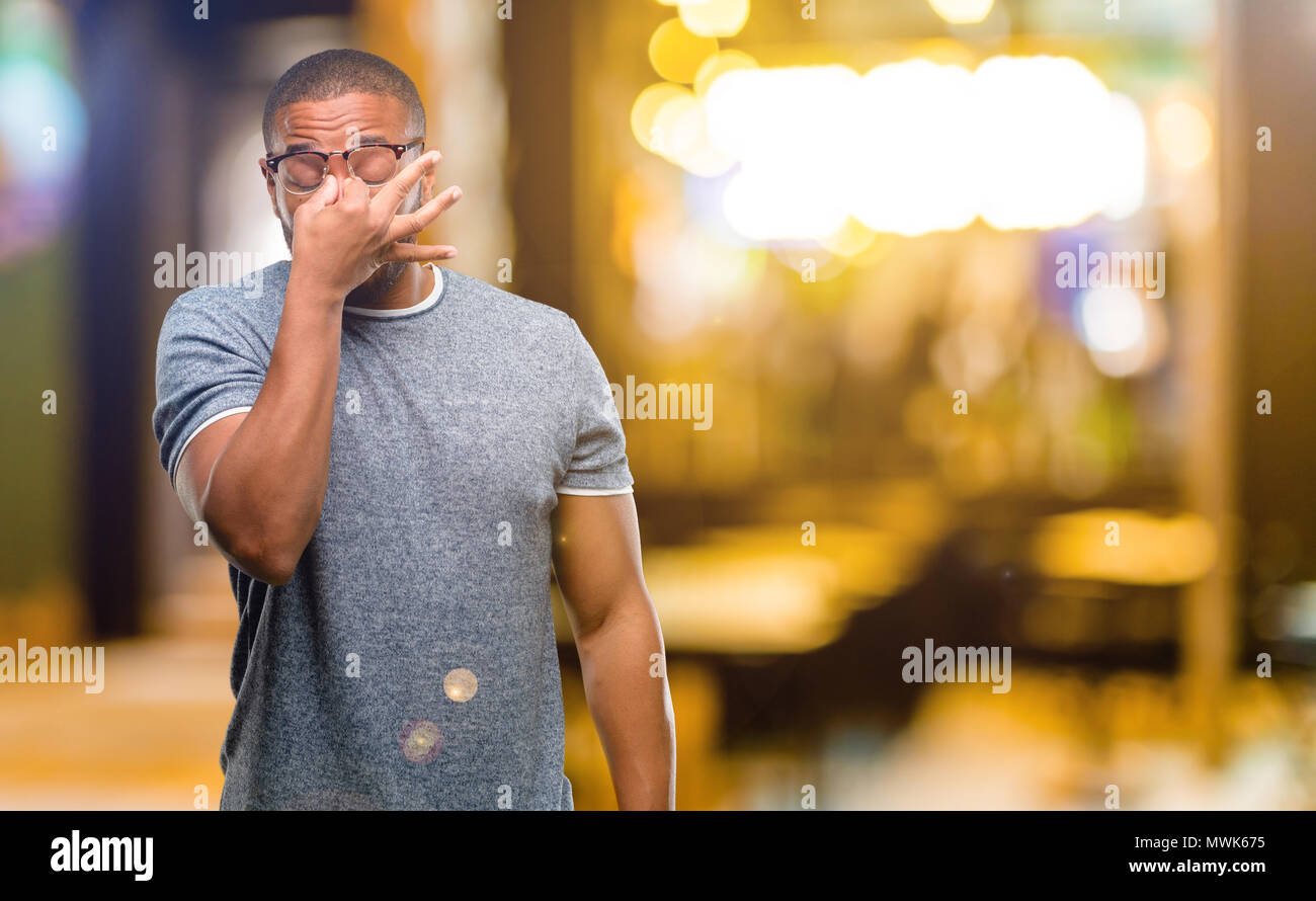 African american man with beard with sleepy expression, being ...
