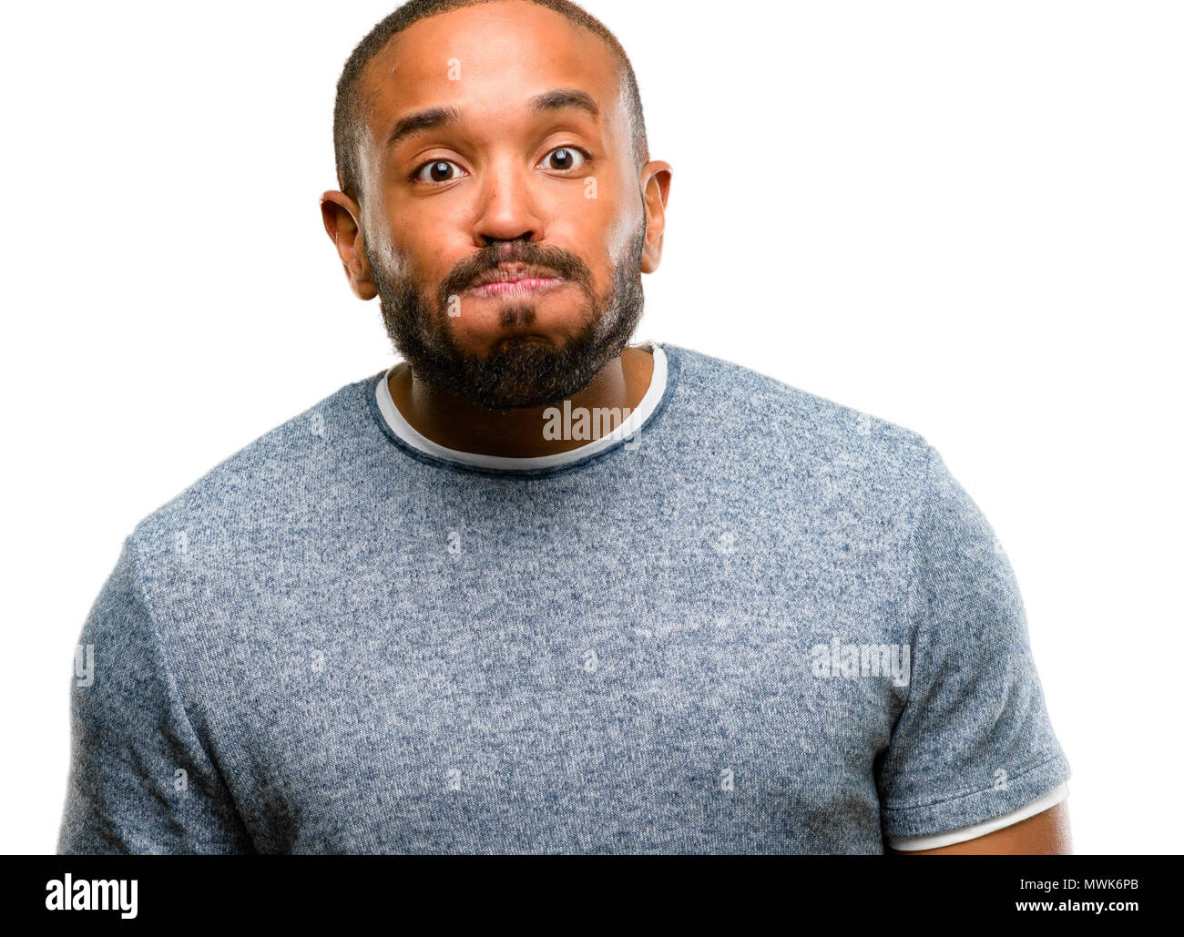 African american man with beard puffing out cheeks, having fun making ...