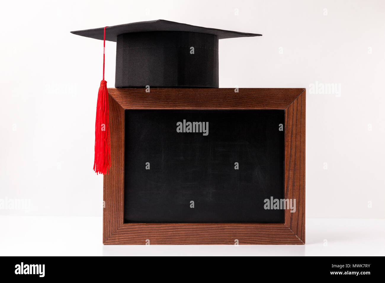 Academic cup on empty blackboard isolated on white Stock Photo - Alamy