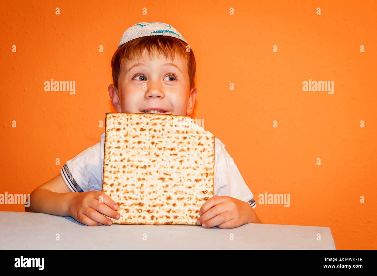 Happy little Jewish child with a kippah on his head looking forward for ...
