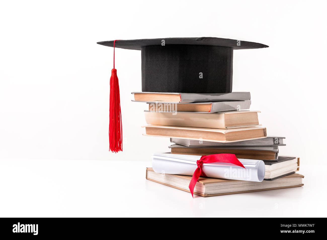 Academic cap on stack of books isolated on white Stock Photo - Alamy