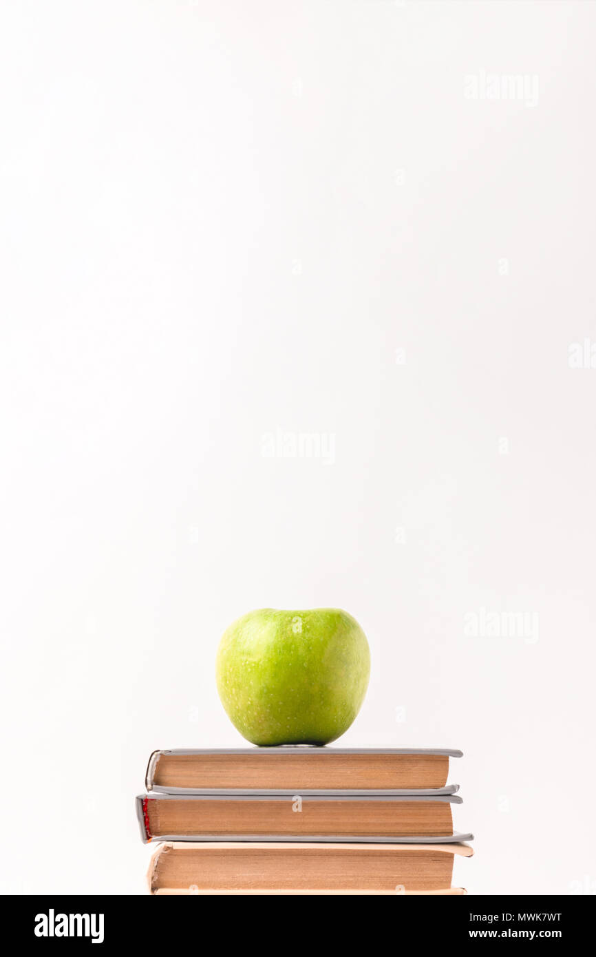 Stack of books with apple on top isolated on white Stock Photo - Alamy