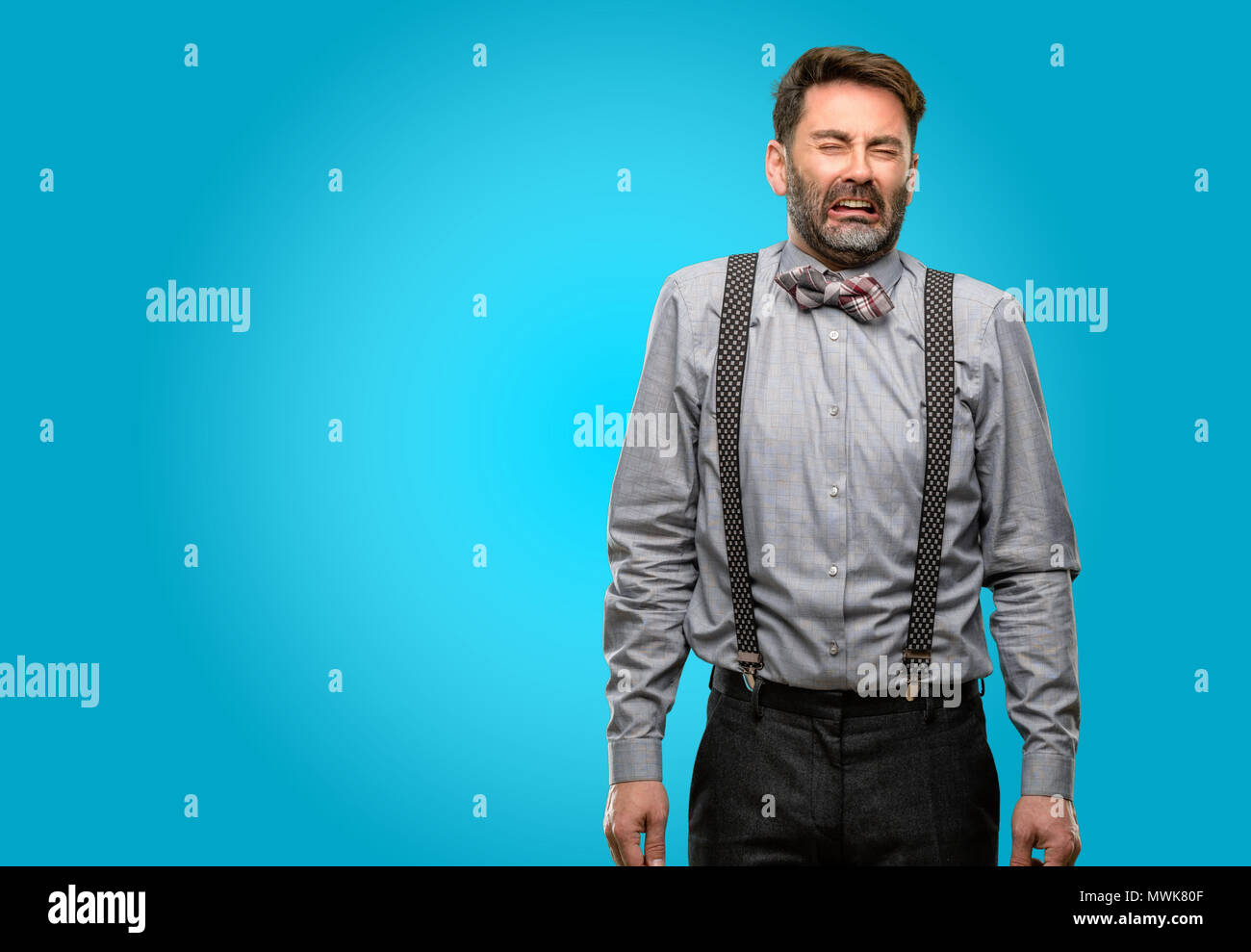 Middle age man, with beard and bow tie crying depressed full of sadness ...