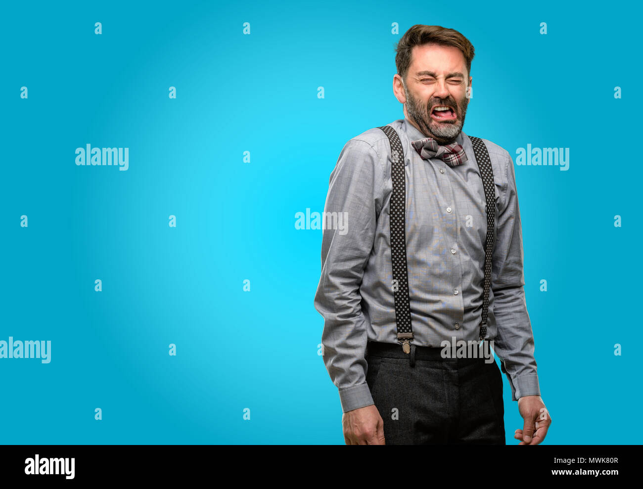 Middle age man, with beard and bow tie crying depressed full of sadness ...