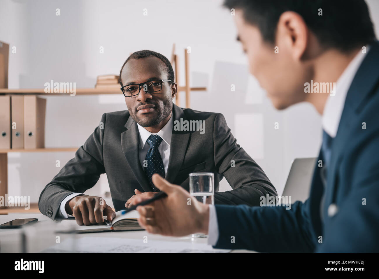 business colleagues having conversation in modern office Stock Photo ...