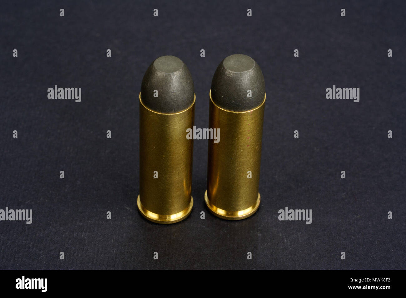 The .45 caliber revolver cartridges on black background Stock Photo - Alamy