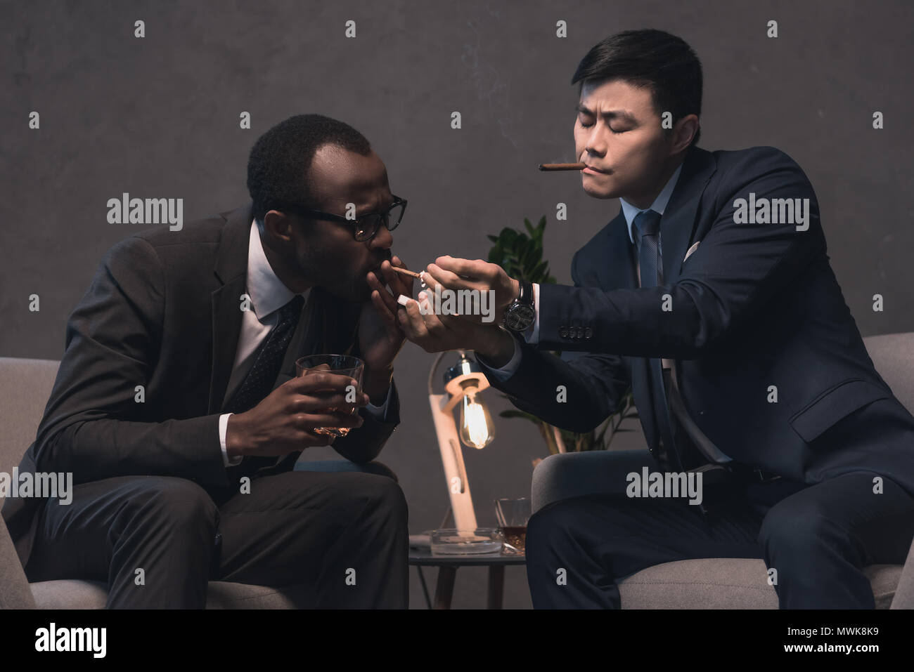 successful multiethic businessmen smoking cigars Stock Photo - Alamy
