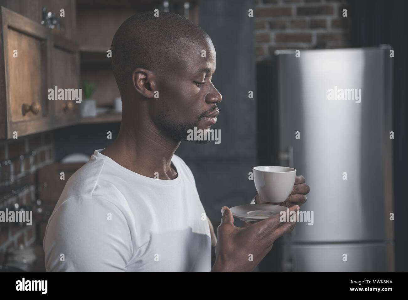 Handsome african american man having his morning coffee at home Stock ...