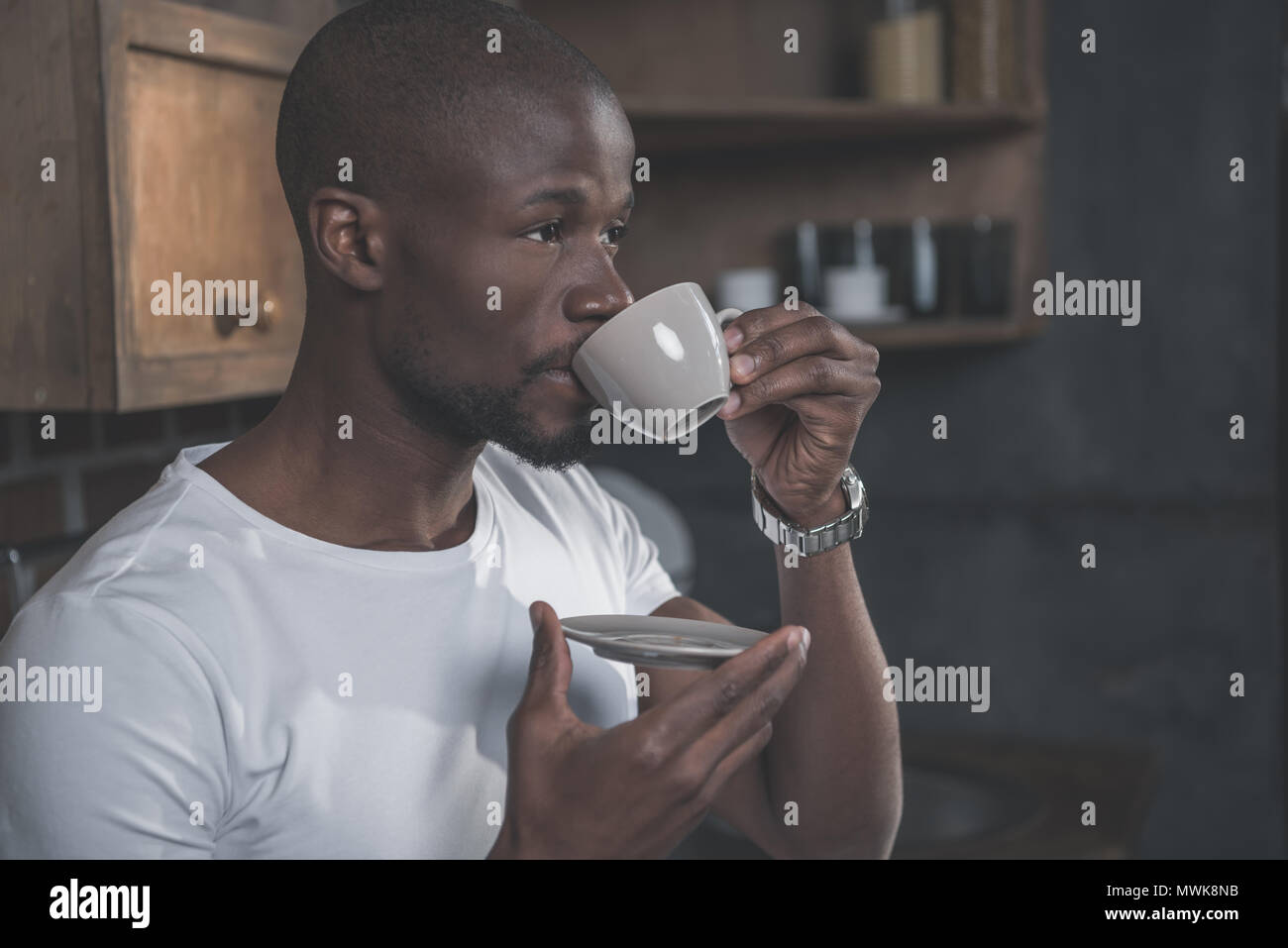 Handsome african american man having his morning coffee at home Stock ...