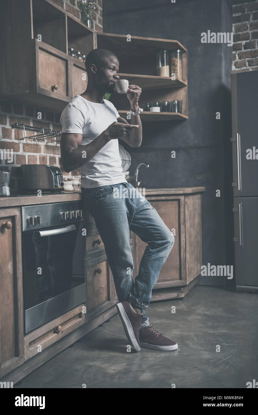 Handsome african american man having his morning coffee at home Stock ...