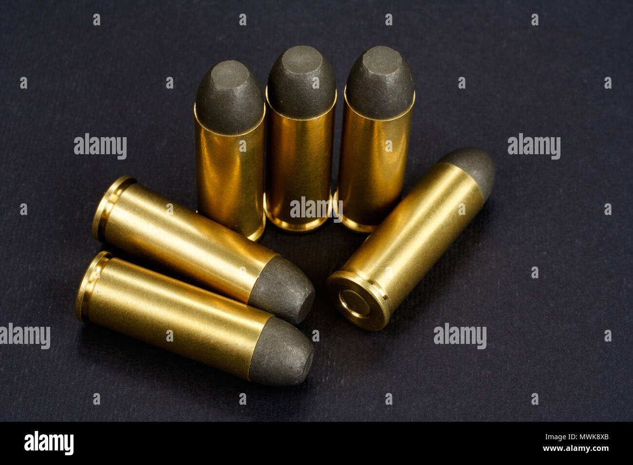 The .45 caliber revolver cartridges on black background Stock Photo - Alamy