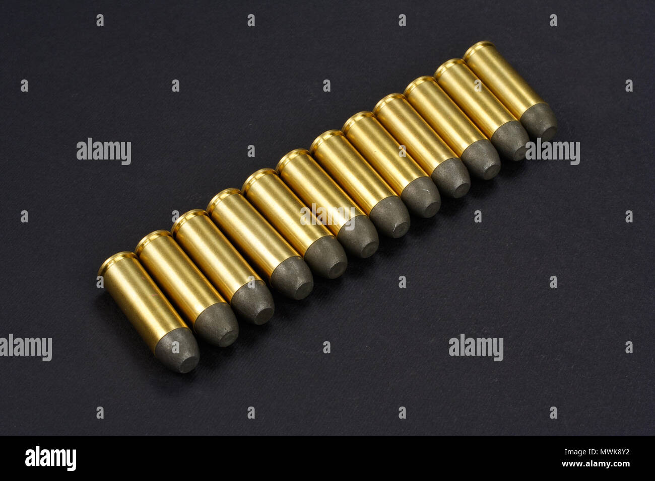The .45 caliber revolver cartridges on black background Stock Photo - Alamy
