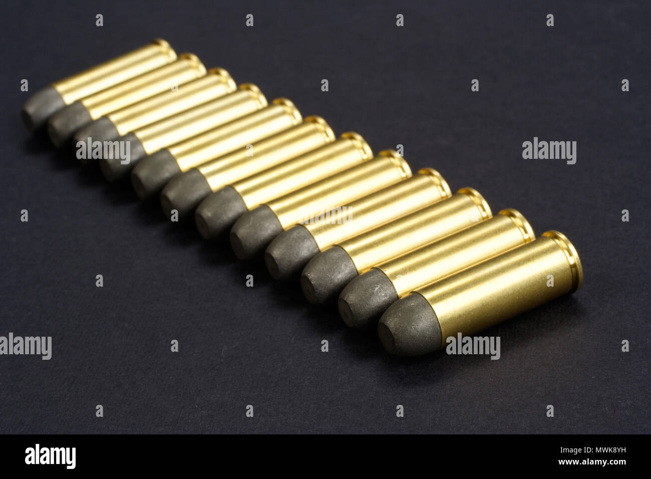 The .45 caliber revolver cartridges on black background Stock Photo - Alamy
