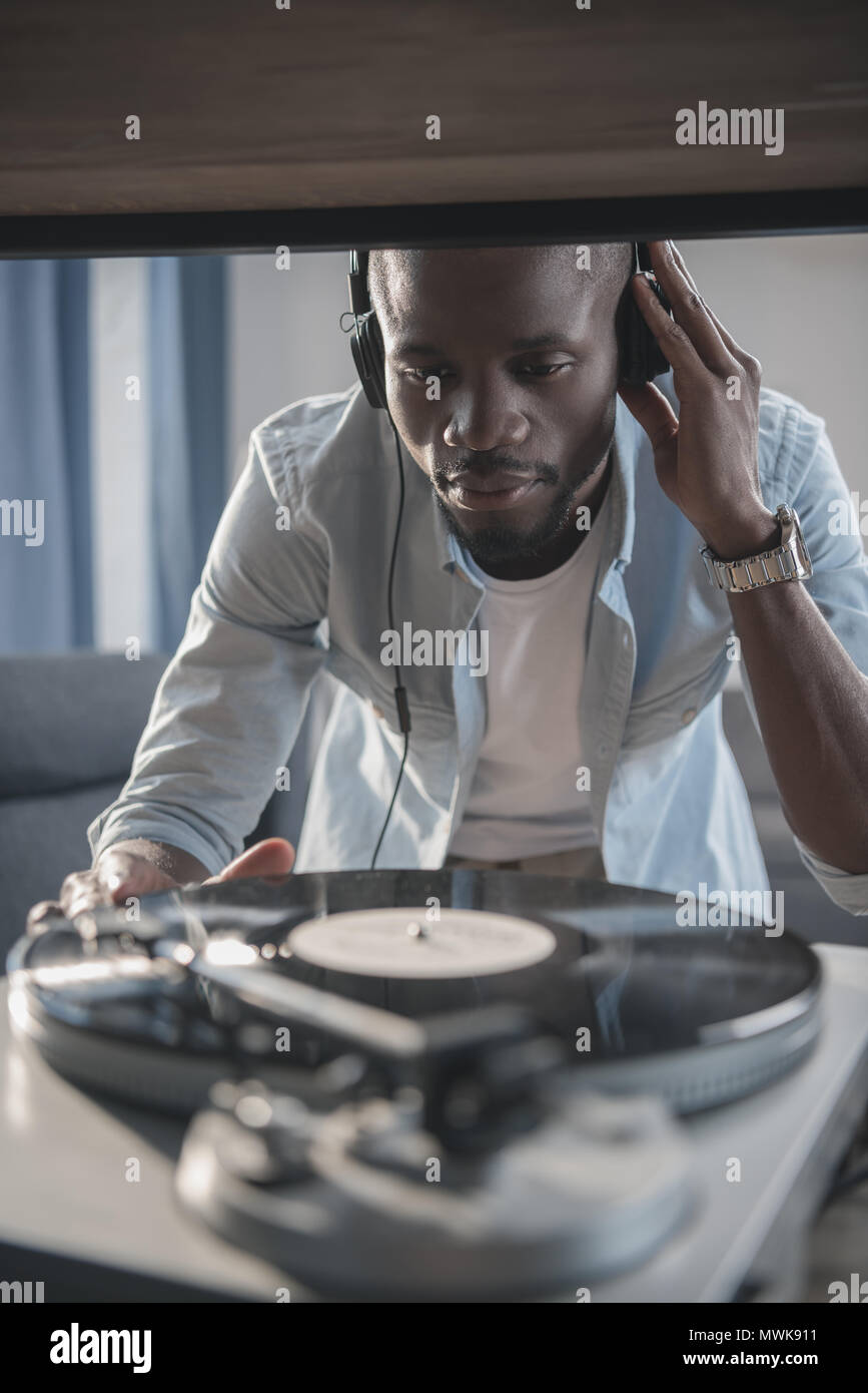 African american man listening vinyl record at home Stock Photo - Alamy