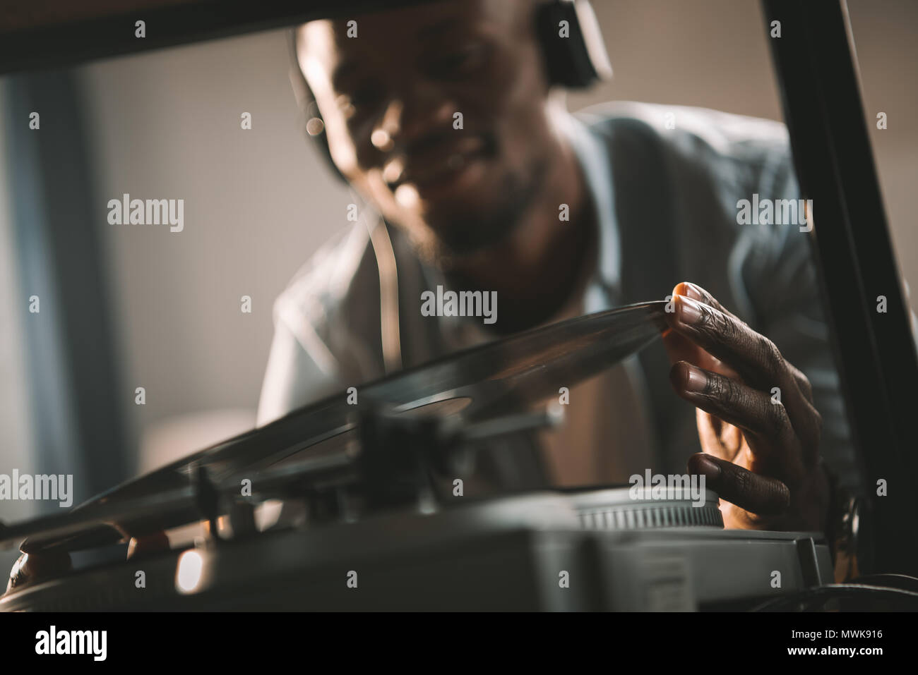 African american man playing vinyl record at home Stock Photo - Alamy