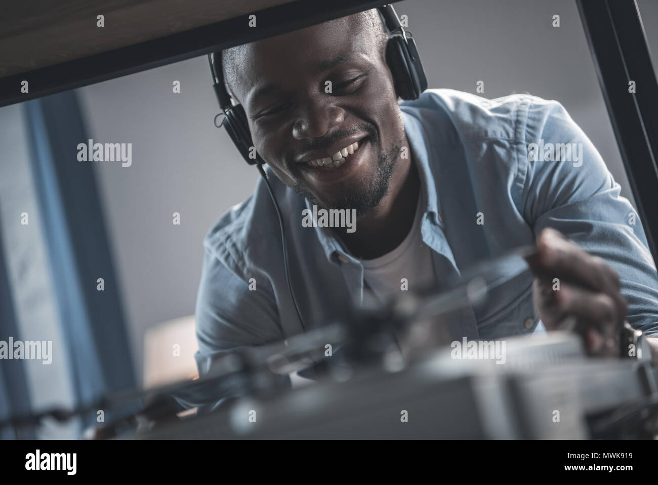African american man playing vinyl record at home Stock Photo - Alamy