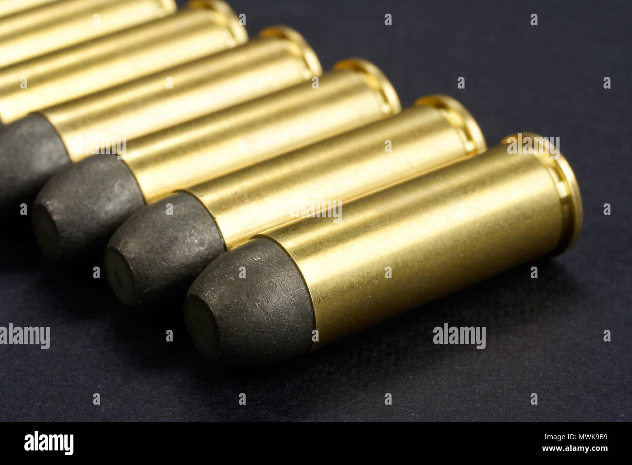 The .45 caliber revolver cartridges on black background Stock Photo - Alamy