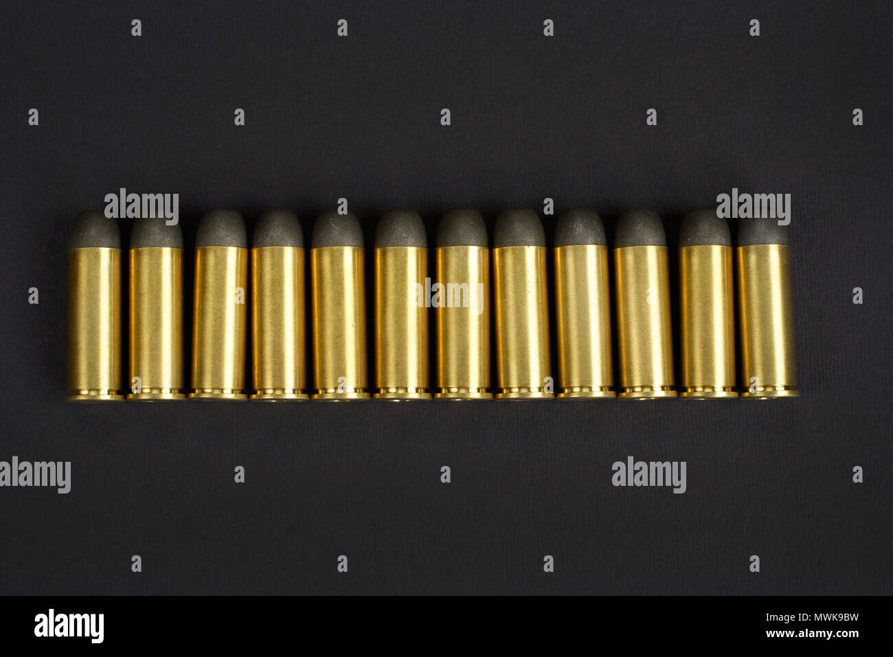 The .45 caliber revolver cartridges on black background Stock Photo - Alamy