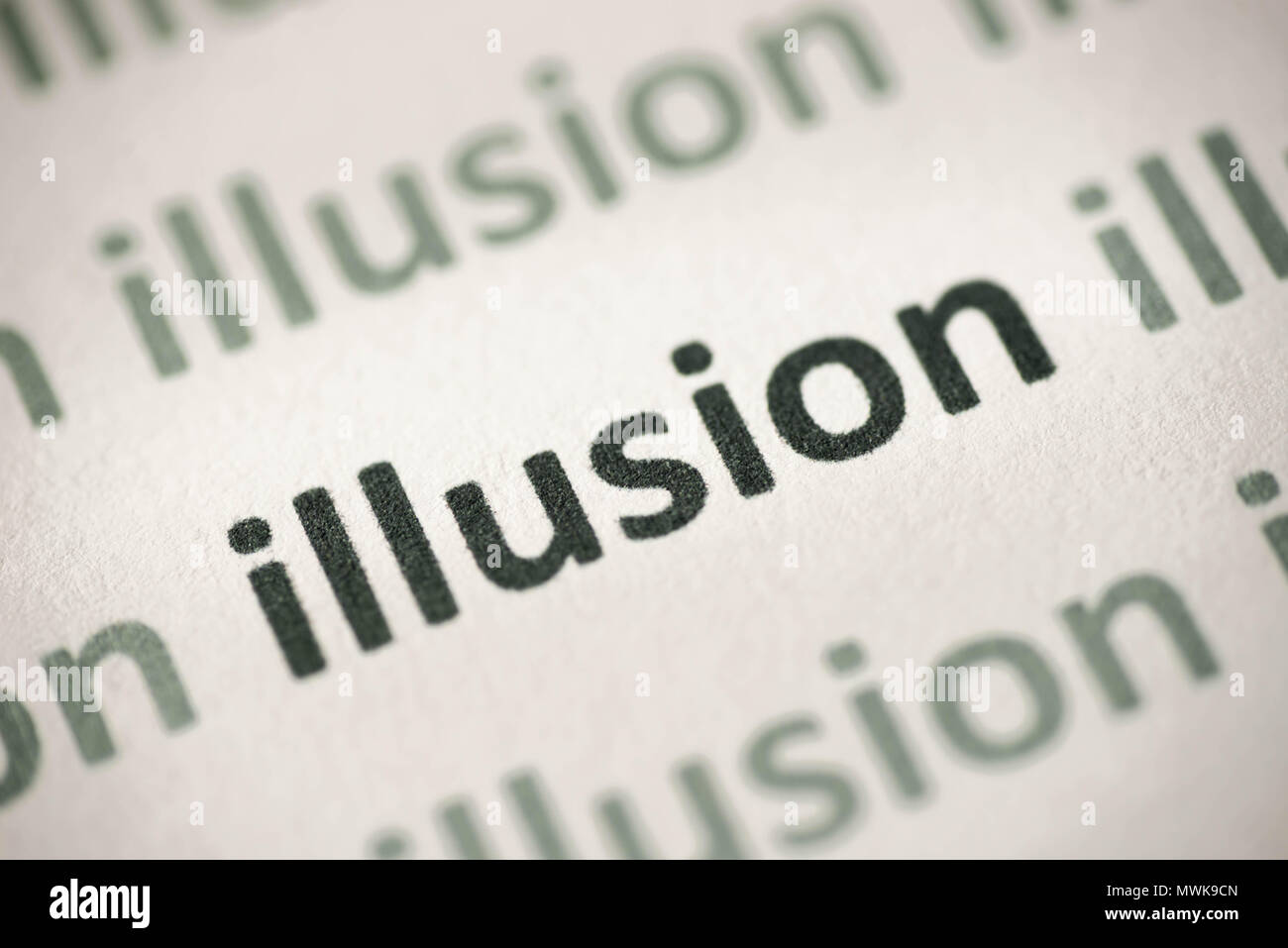 word illusion printed on white paper macro Stock Photo - Alamy